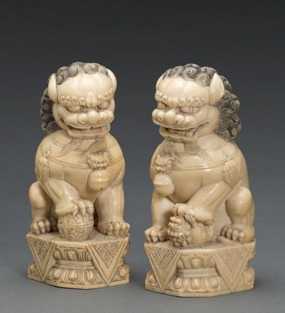 Bonhams : A pair of carved and tinted ivory lion dogs 20th century