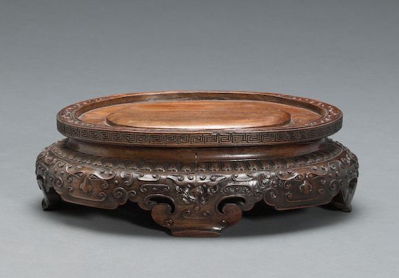 Bonhams : An elaborately carved and pieced wood display stand