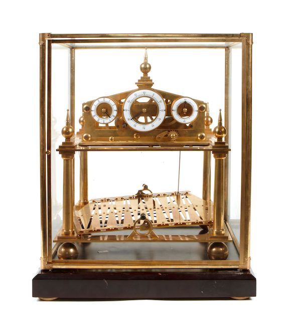 Bonhams : A brass oscillating path rolling ball clock
