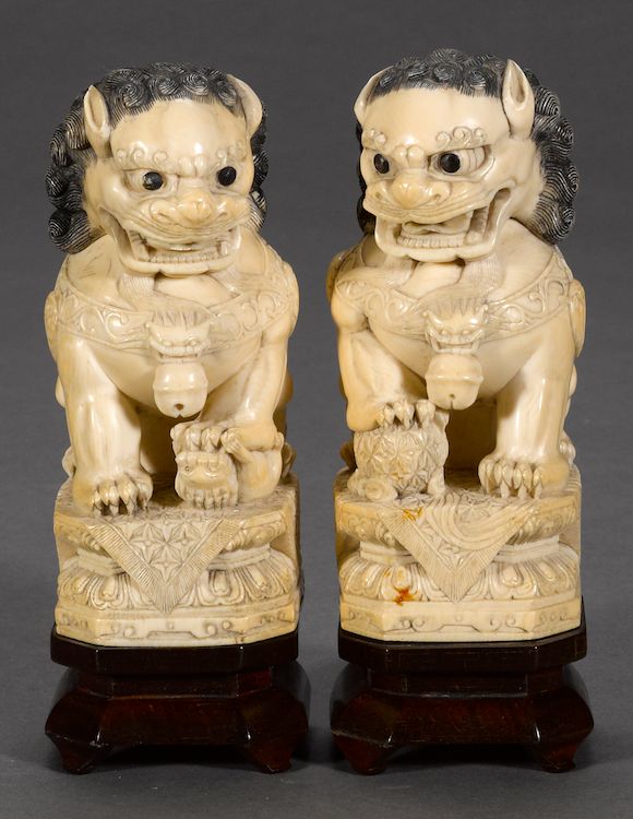 Bonhams : A pair of carved and tinted ivory lion dogs 20th century