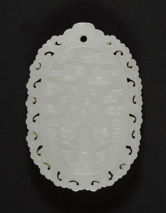 Bonhams : A white jade oval plaque with auspicious emblems
