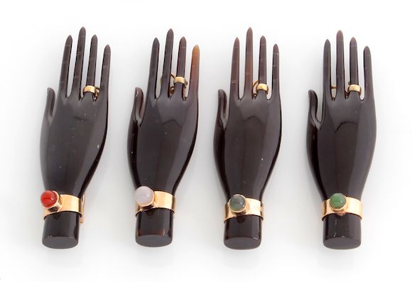 Bonhams : A collection of four carved horn, gem-set and 10k gold hand ...