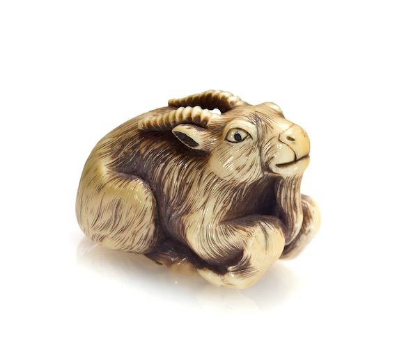 Bonhams : An ivory netsuke of a reclining goat After Kokei, 19th century