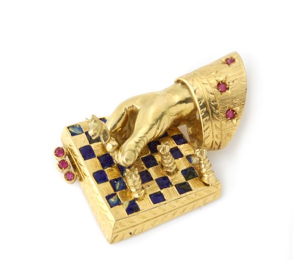 Bonhams : A red stone and enamel chess player brooch