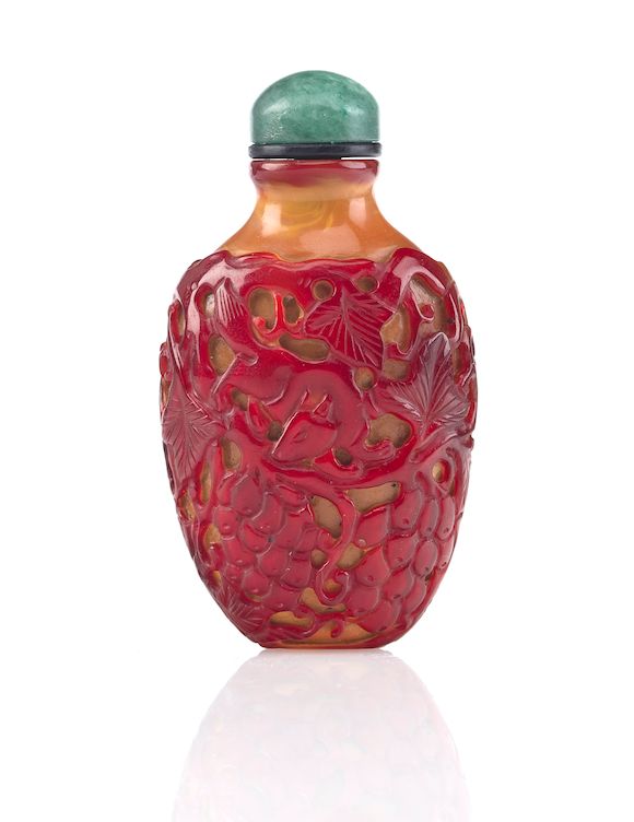Bonhams : An orange and red glass overlay snuff bottle