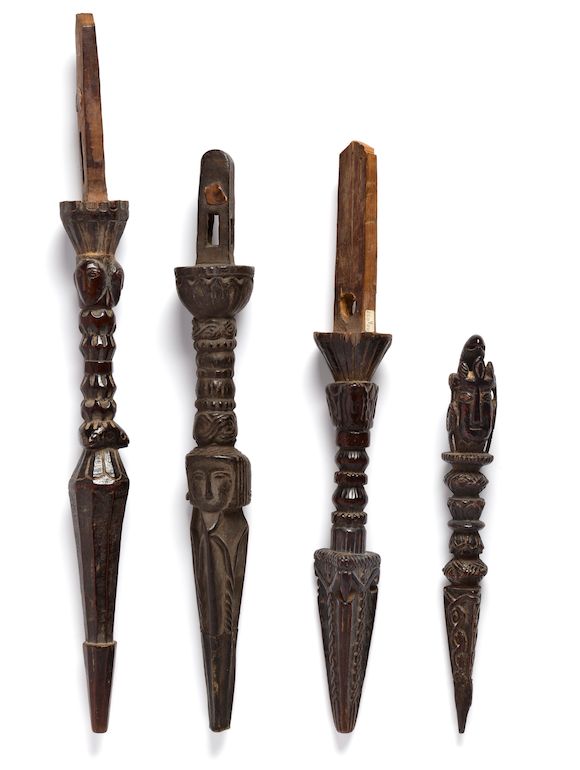 Bonhams : A wooden ritual dagger and three wooden ritual drum handles ...