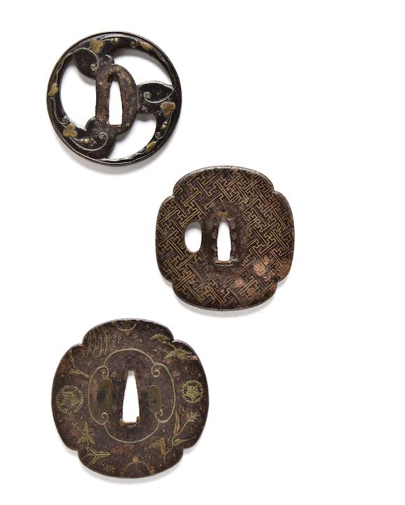 Bonhams : Three brass-inlaid iron tsuba 17th-18th century