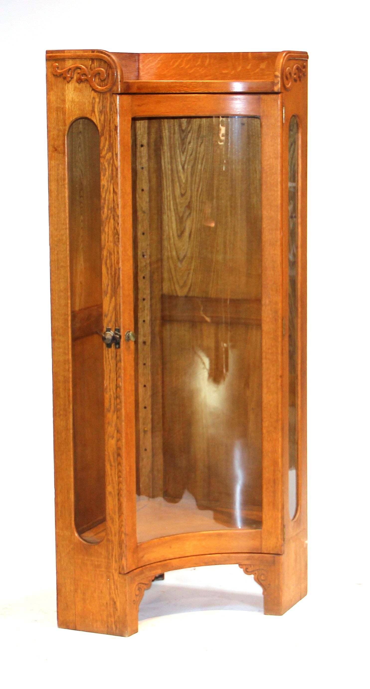 Bonhams : An American oak concave corner vitrine cabinet late 19th century