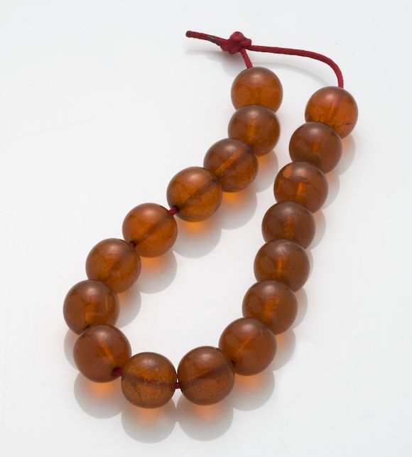 Bonhams : A string of seventeen amber beads