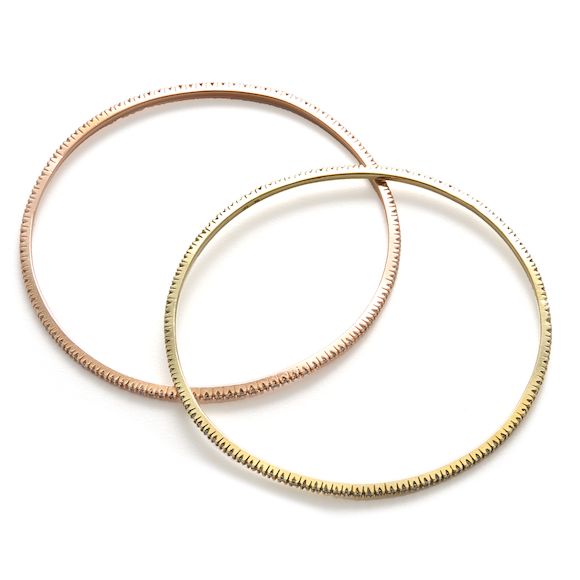Bonhams : A pair of diamond and 14k gold bangles
