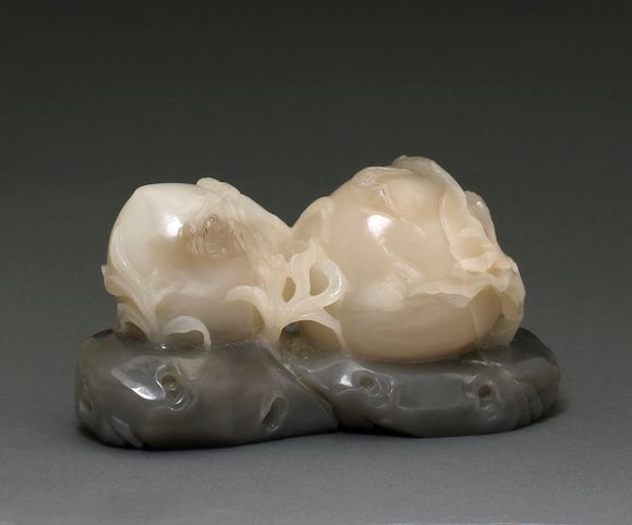 Bonhams : A white and gray jade carving of peaches