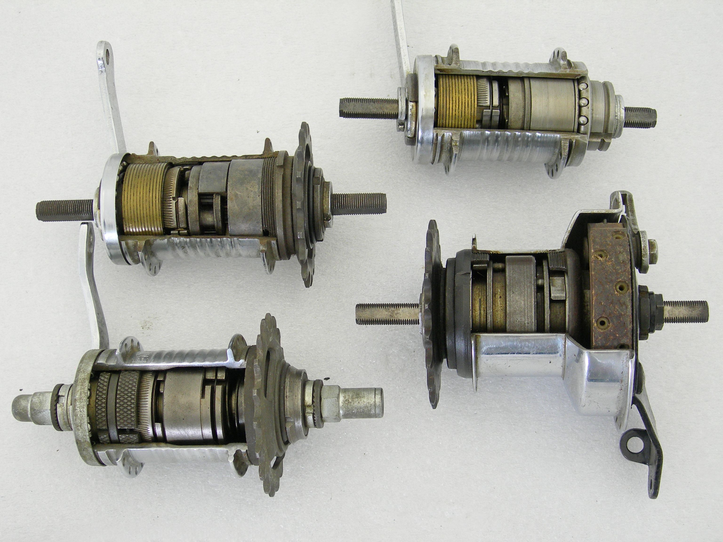 Bonhams Cars : A group of four cutaway Sturmey Archer multi speed hubs.