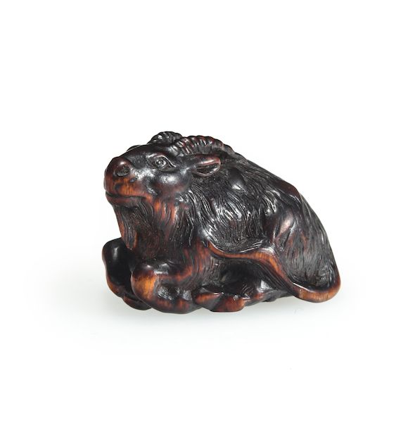 Bonhams : A wood netsuke of a recumbent goat By Kokei, early 19th century