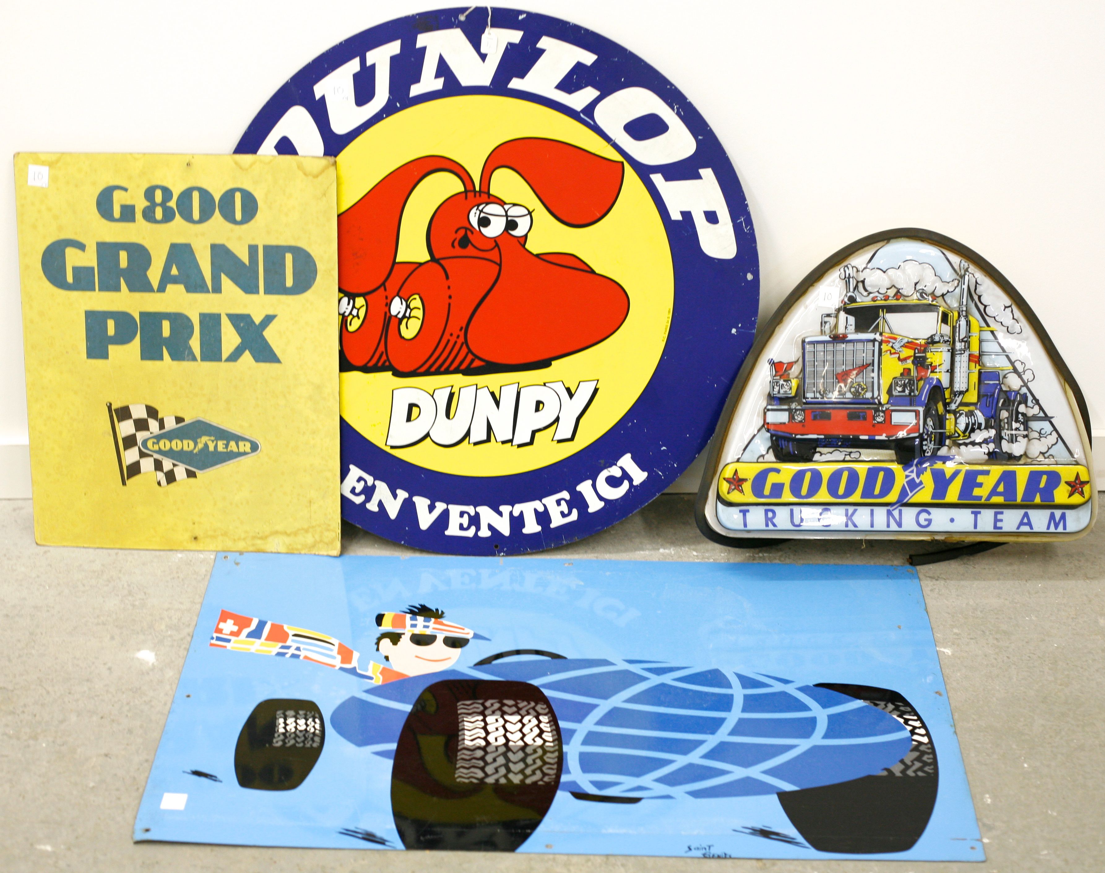 Bonhams Cars : A mixed grouping of tire advertising signs,