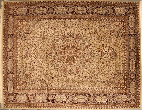 Bonhams : A Machine made carpet size approximately 9ft. 1in. x 11ft. 10in.
