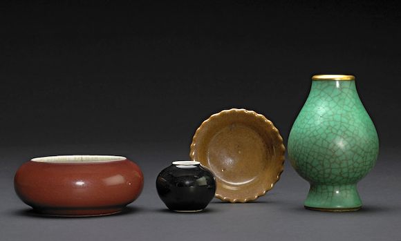 Bonhams : A group of four small monochrome glazed porcelain containers ...