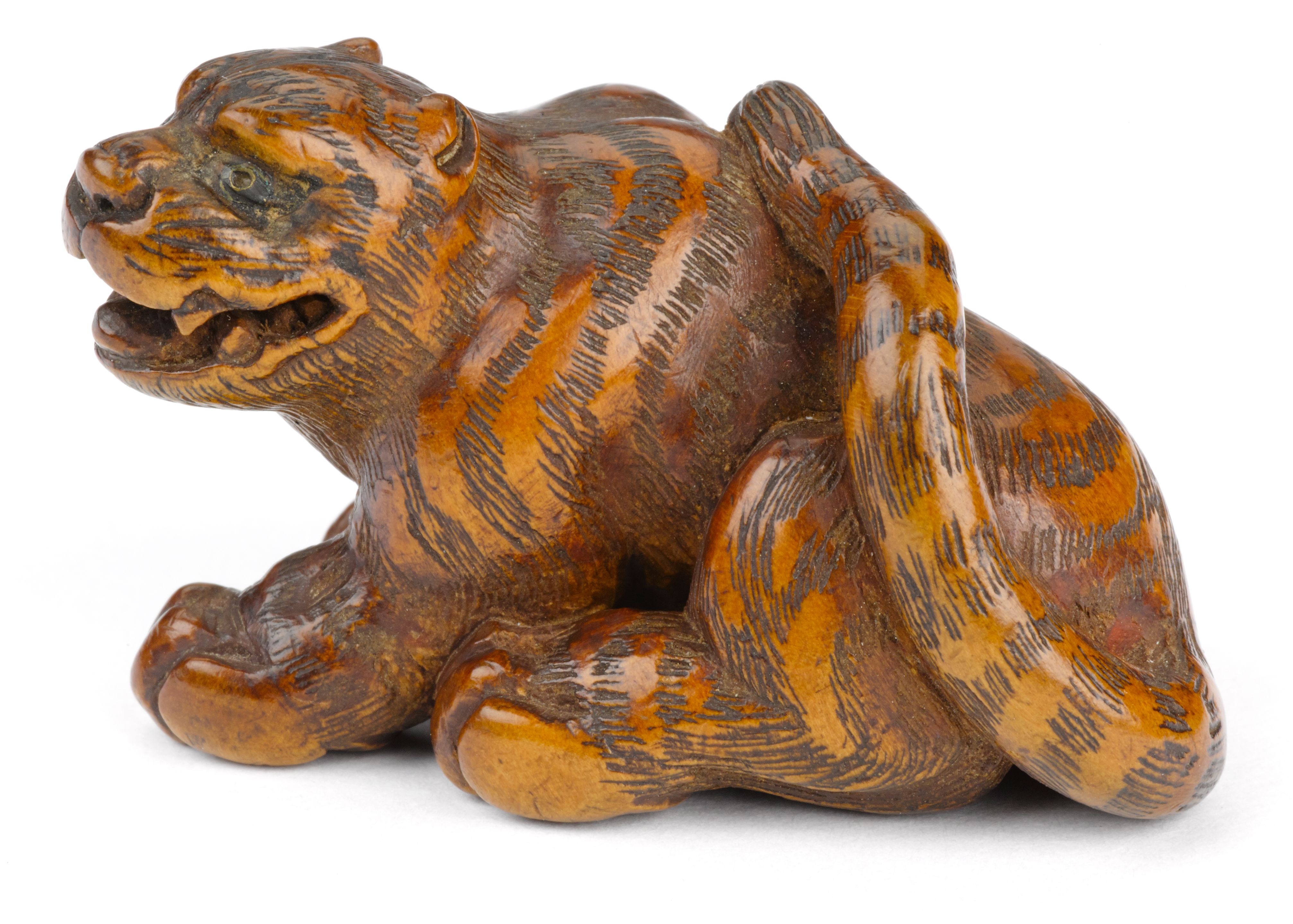 Bonhams : A wood netsuke of a crouching tiger By Kokei, Ise, Edo period ...