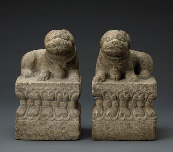 Bonhams : A pair of stone dogs on pedestals
