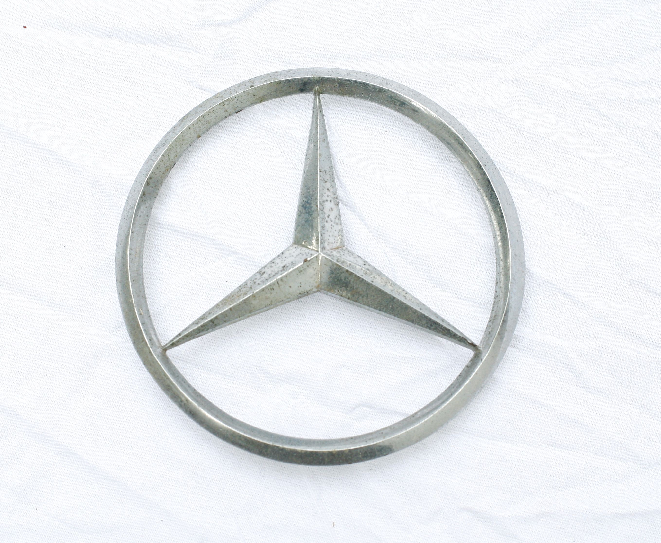 Bonhams Cars : An original Mercedes 300sl emblem.