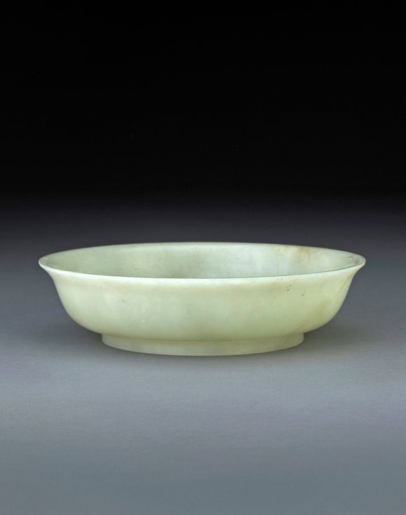 Bonhams : A greenish-white jade shallow bowl Qianlong mark