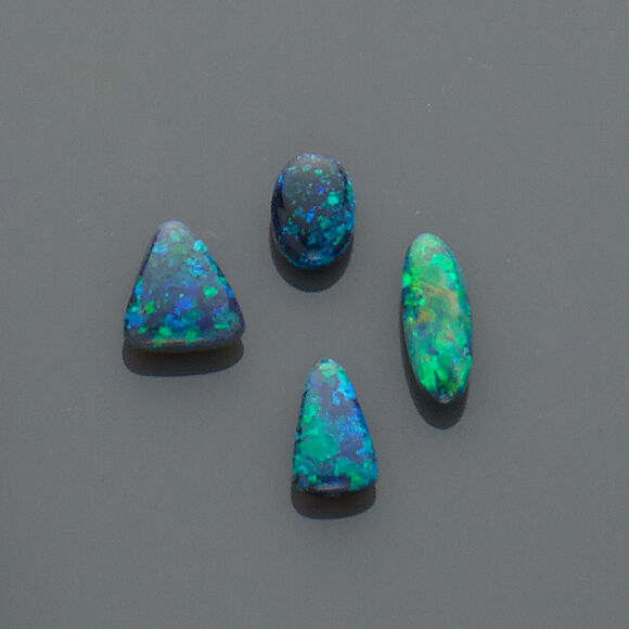 Bonhams : Group of Four Black Opals with Blue-Green Fire