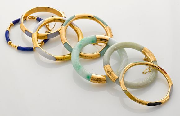 Bonhams : A collection of jadeite jade and 14k gold bangle bracelets together with a lapis ...