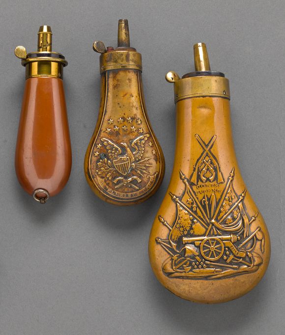 Bonhams : A lot of three powder flasks for Colt revolvers