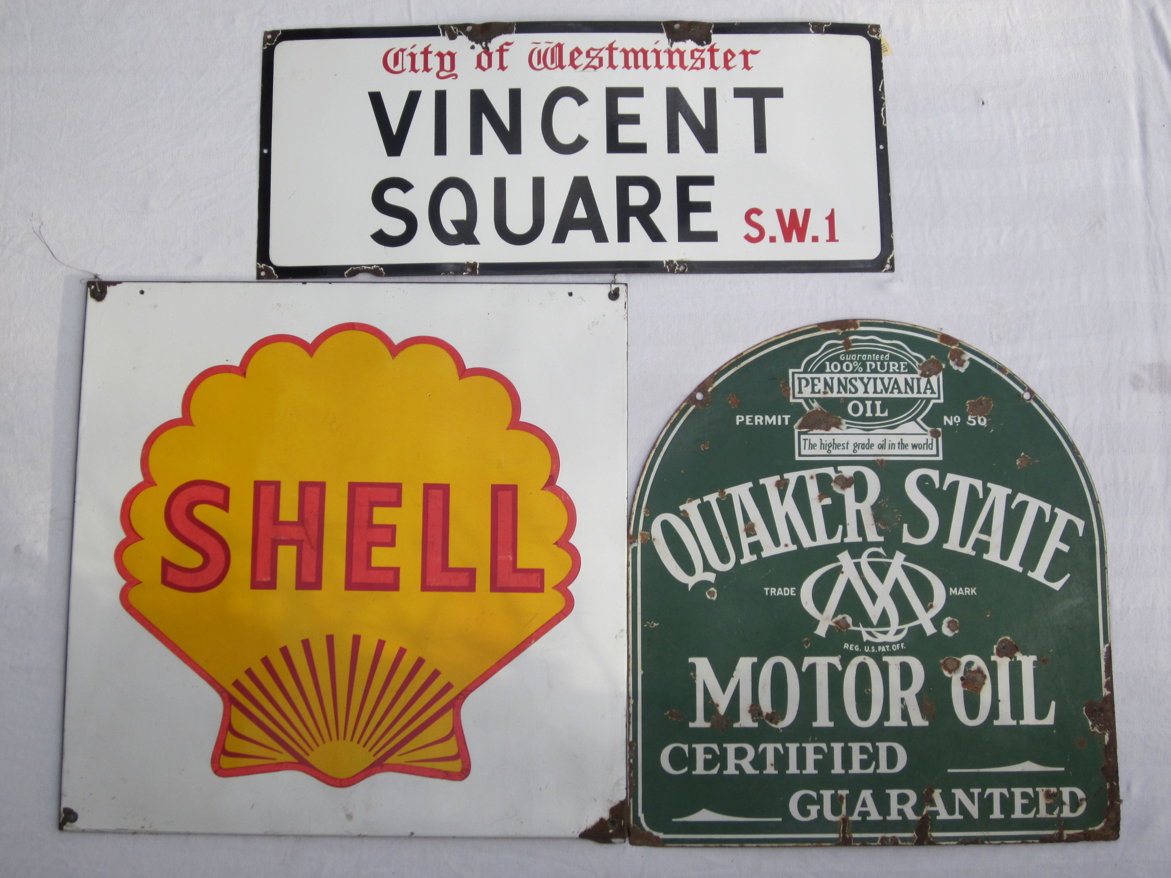 Bonhams Cars : A lot of three enameled advertising signs,