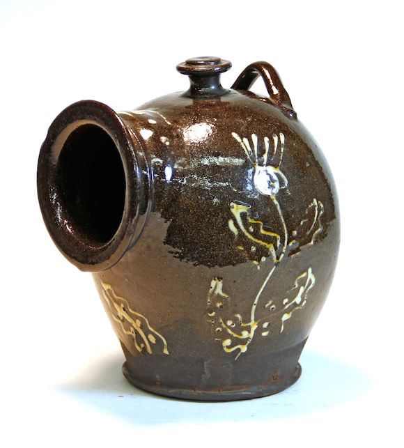 Bonhams : A slip decorated redware hanging birdhouse