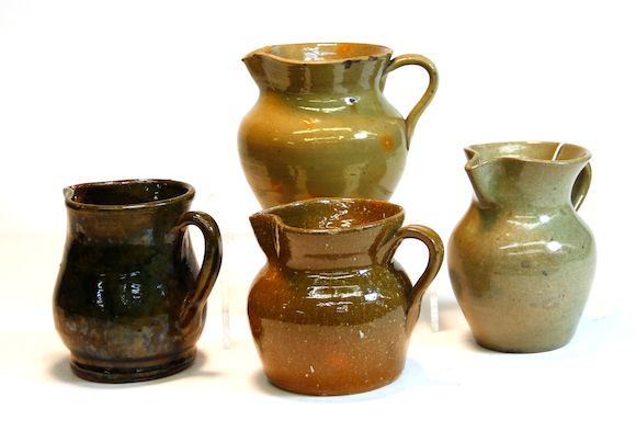Bonhams : Four American glazed redware pitchers 19th century