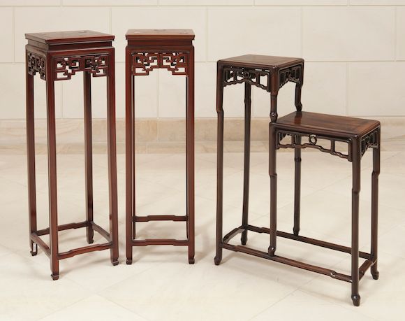 Bonhams : A two-tiered rosewood stand and a pair of Chinese hardwood stands
