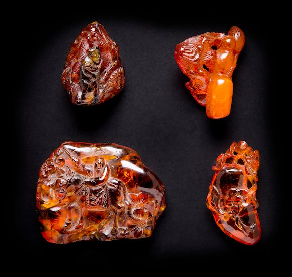 Bonhams : A group of four amber carvings 19th century