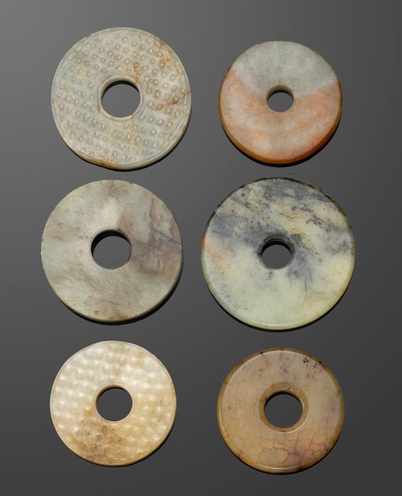 Bonhams : A group of six carved jade and hardstone bi discs