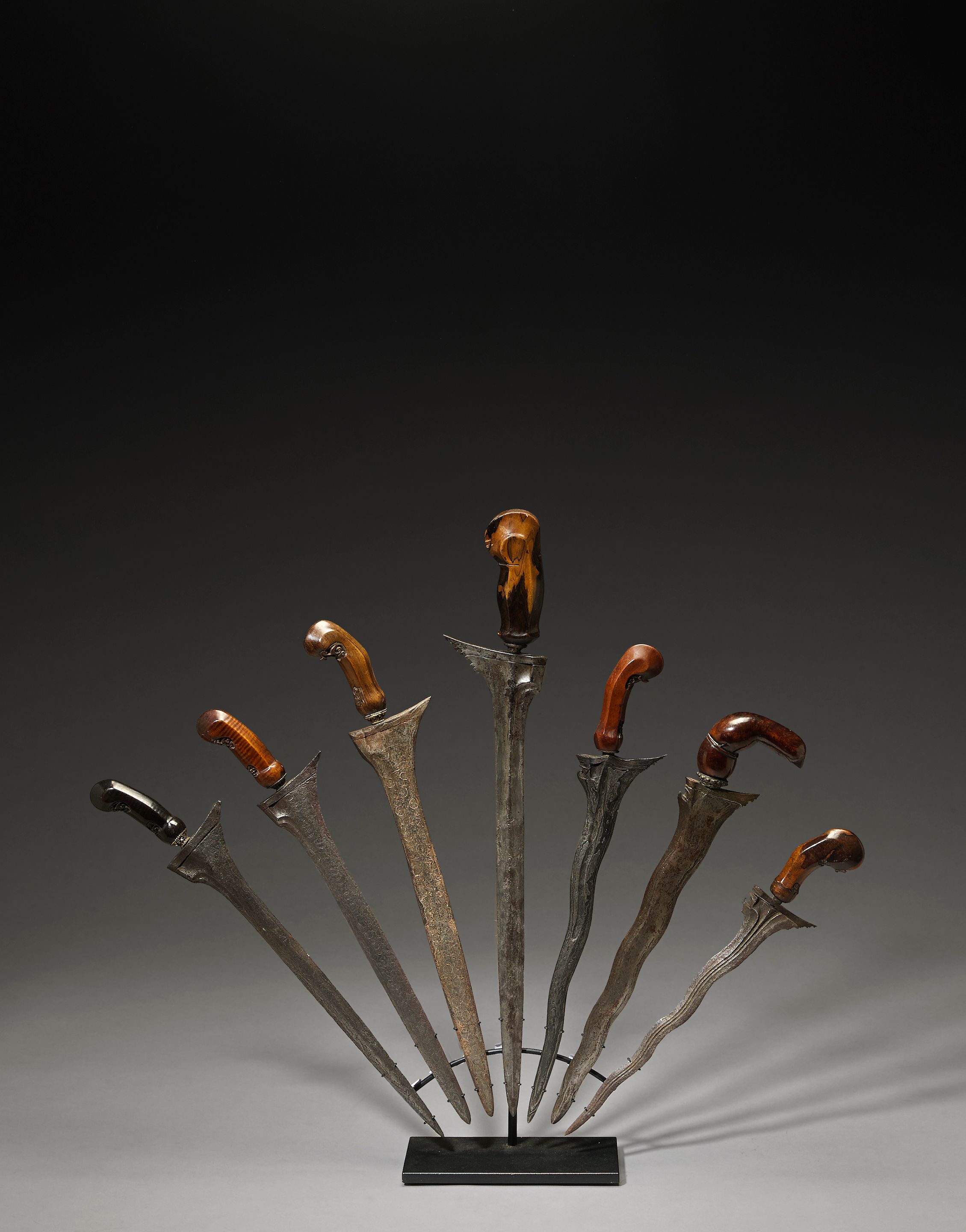 Bonhams : A group of seven Indonesian keris with custom stand