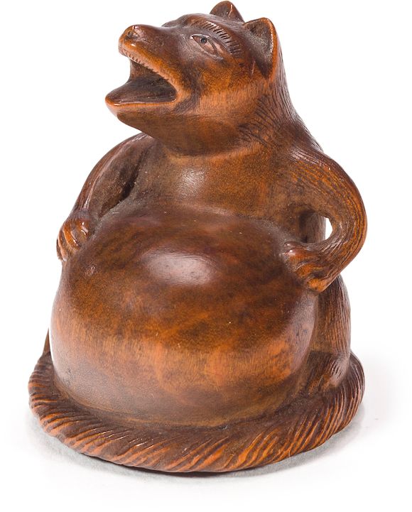 Bonhams : A wood netsuke of a tanuki (raccoon dog) By Tomonobu, Edo ...
