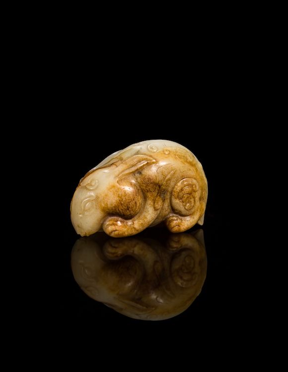Bonhams : A WHITE AND RUSSET JADE CARVING OF A RABBIT 17th/18th century