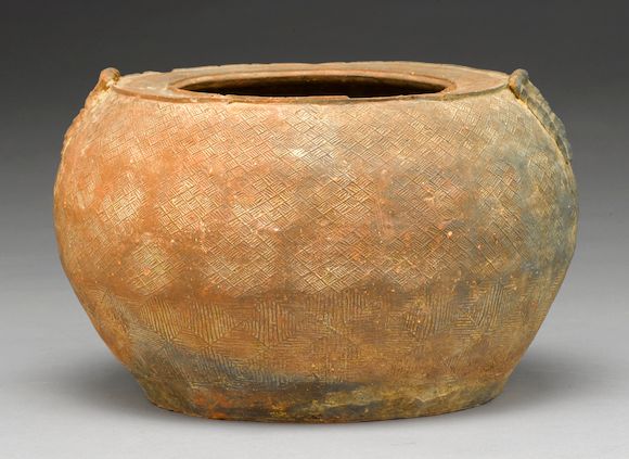 Bonhams : A red pottery jar with impressed decoration Warring States period