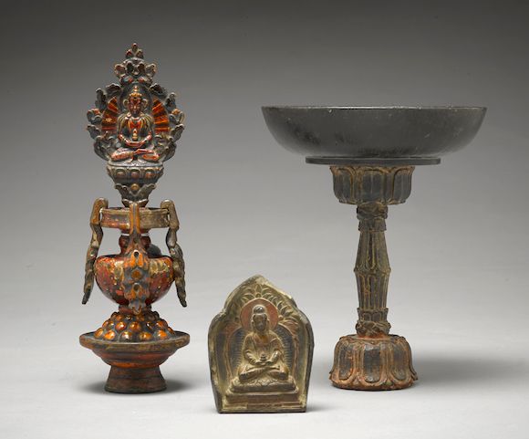 Bonhams : A clay tsa-tsa and two wood altar items Tibet, 18th/19th century