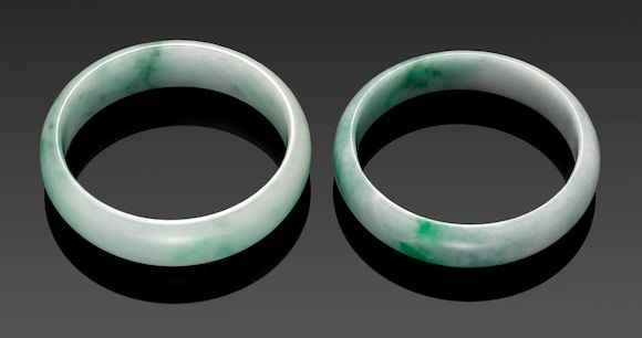 Bonhams : Two Mottled green jadeite bangles