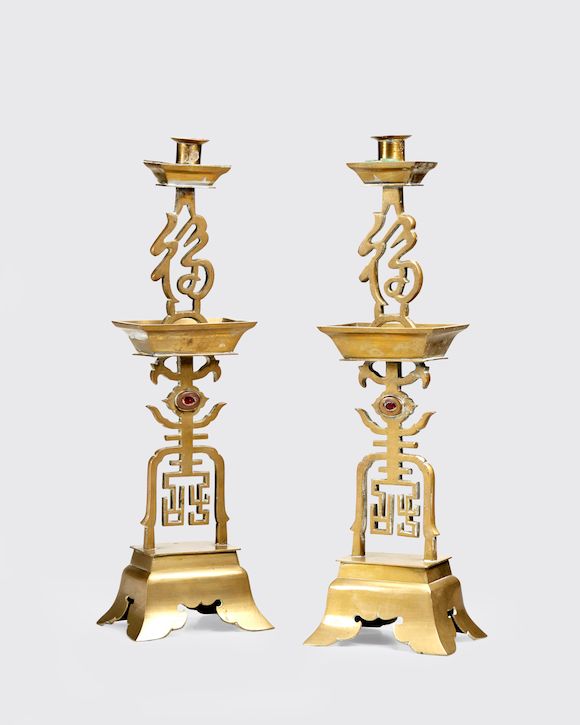 Bonhams : A pair of brass 'Fu Shou' candle stands Republic period