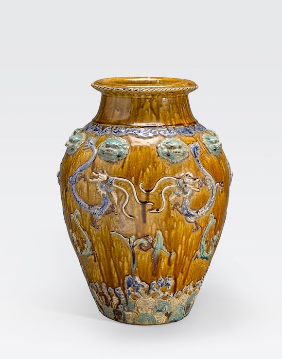 Bonhams : A tall amber ground storage jar with polychrome raised relief ...