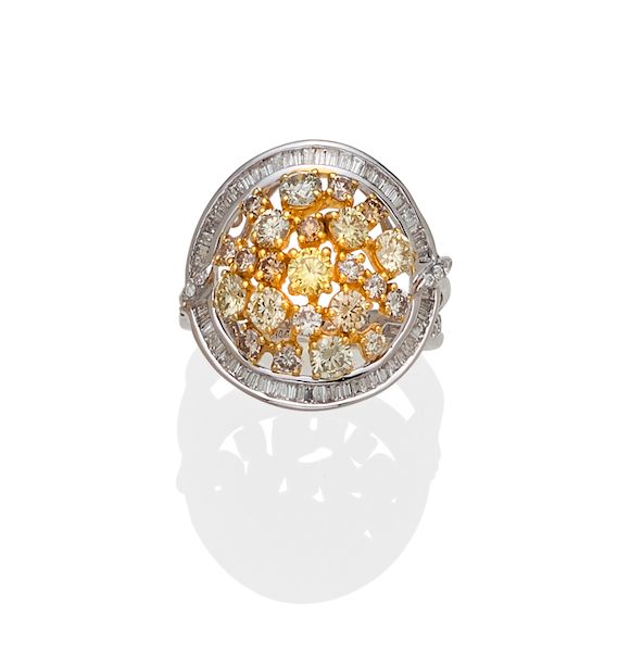Bonhams : A colored diamond, diamond and 18k bi-color gold cluster ring