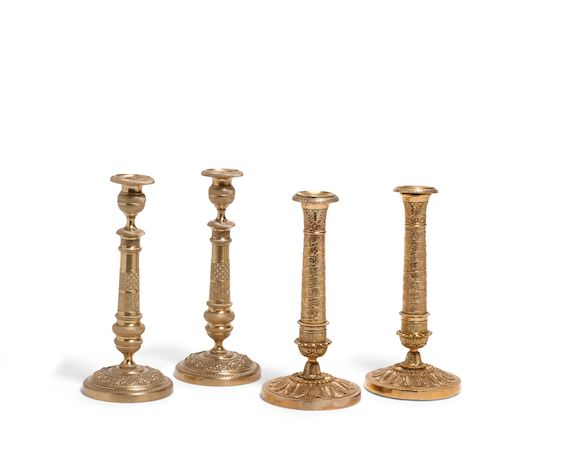 Bonhams : Two pairs of French Neoclassical style gilt metal candlesticks