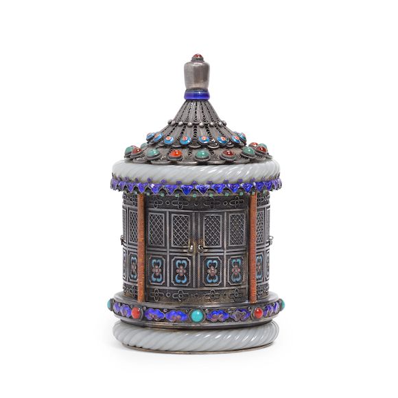 Bonhams : Two jade bangles mounted to a lidded metal box