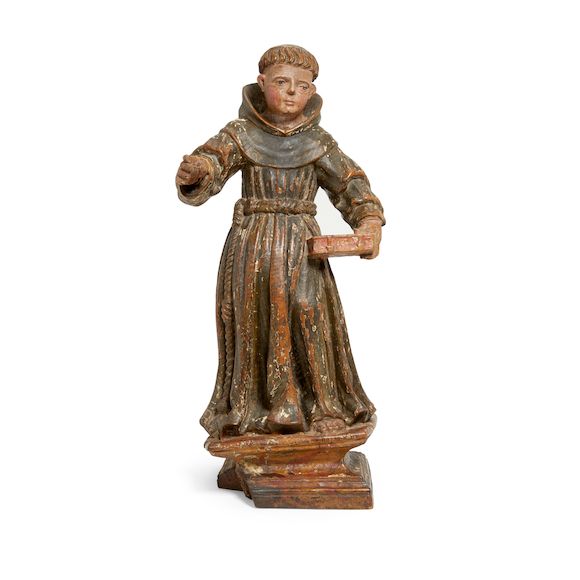 Bonhams : A SPANISH POLYCHROMED CARVED WOOD FIGURE OF A MONK WITH A BOOK