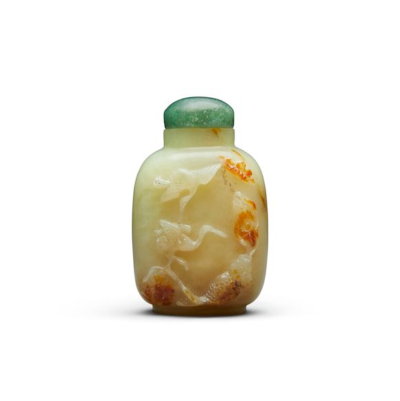 Bonhams : A carved yellow jade snuff bottle with russet inclusions