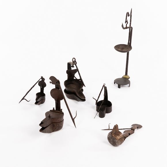 Bonhams Skinner : Six Wrought Iron Betty Lamps and a Stand, 19th century.