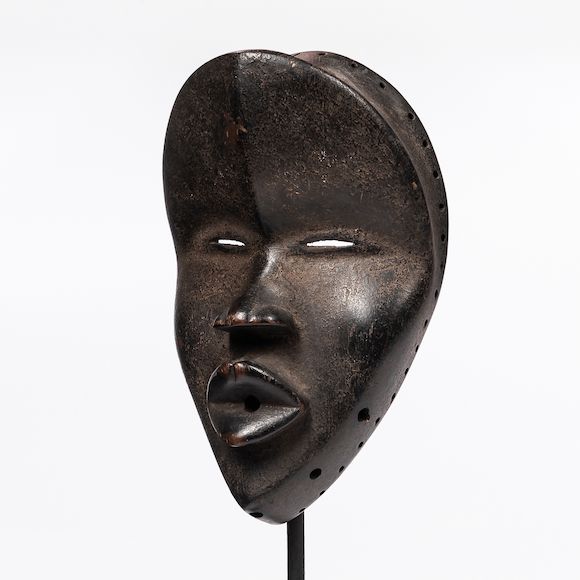 Bonhams Skinner : A Dan face mask ht. 8 1/2, wd. 5 1/4 in.