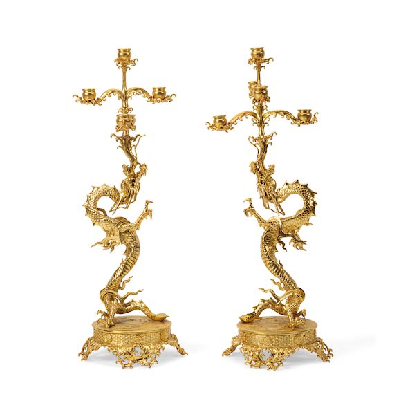 Bonhams : A PAIR OF CHINESE GILT BRONZE DRAGON-FORM FOUR-LIGHT CANDELABRA