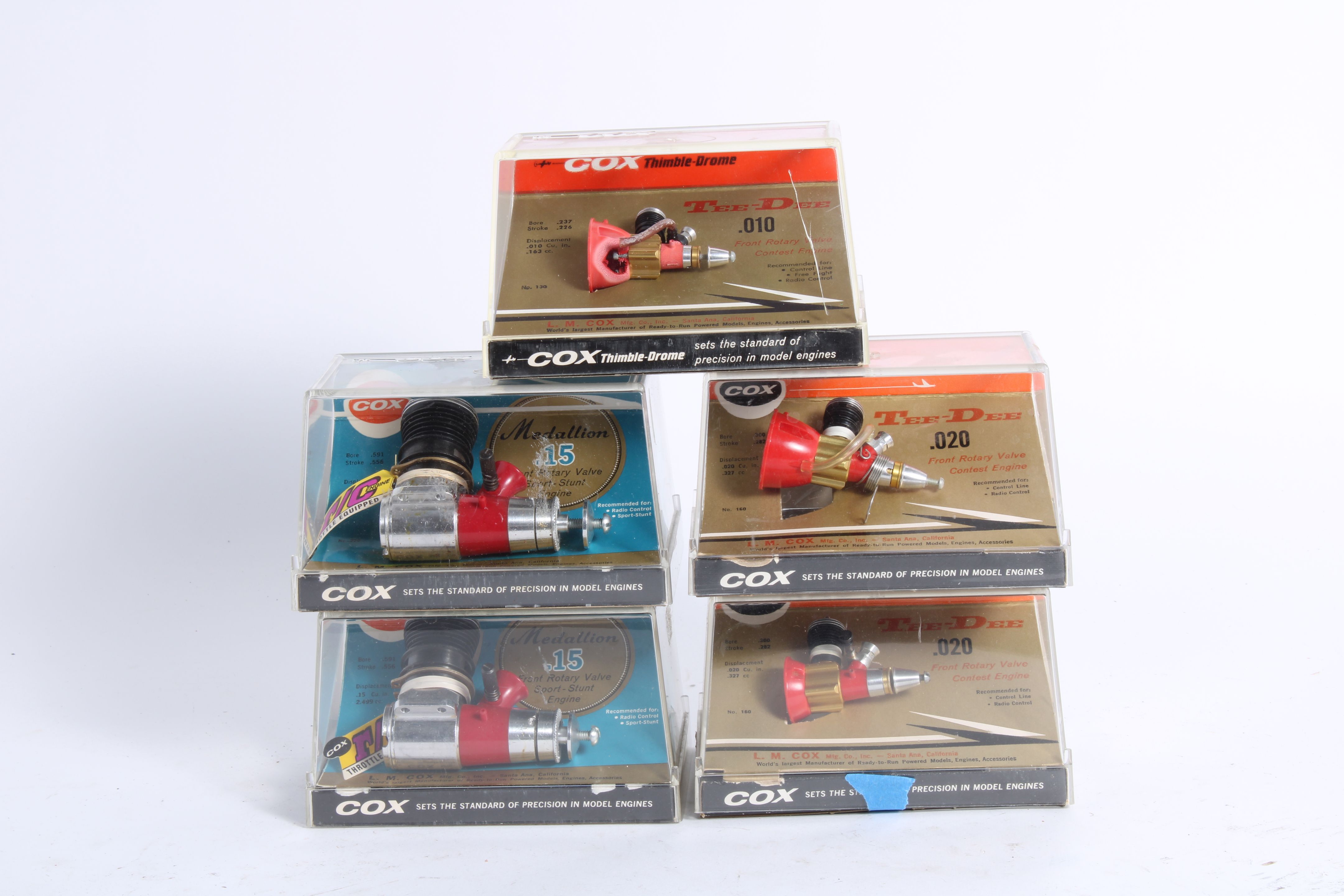 Bonhams Cars : Five Cox gas powered miniature engines in Perspex shop display boxes, (5)